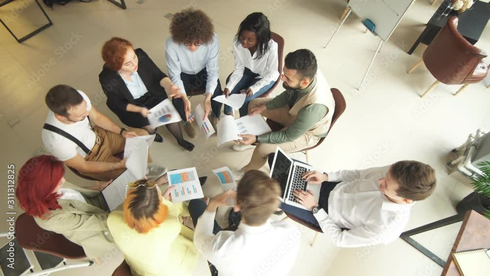 Fast and active teamwork of company employees, colorful graphs and ...