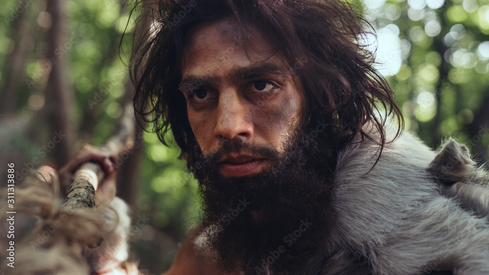 Portrait of Primeval Caveman Wearing Animal Skin and Fur Hunting with a ...