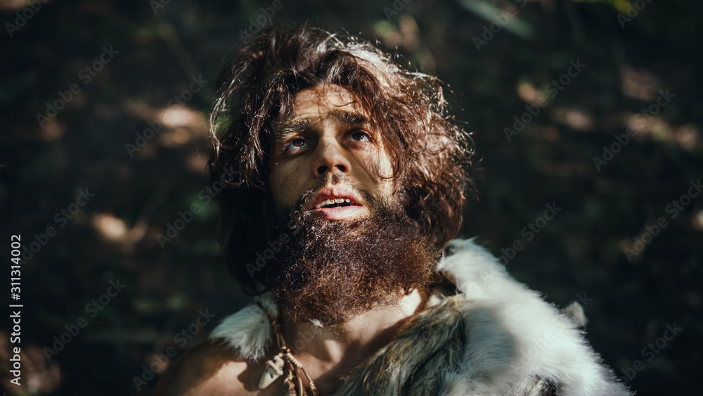 Portrait of Primeval Caveman Wearing Animal Skin Raises Hands to Heaven ...
