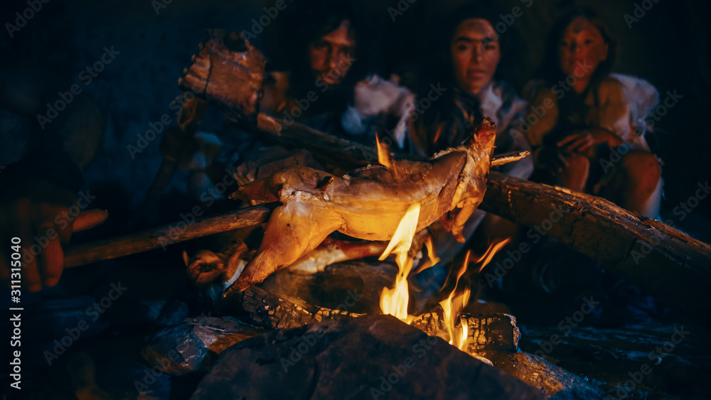 Neanderthal or Homo Sapiens Family Cooking Animal Meat over Bonfire and ...