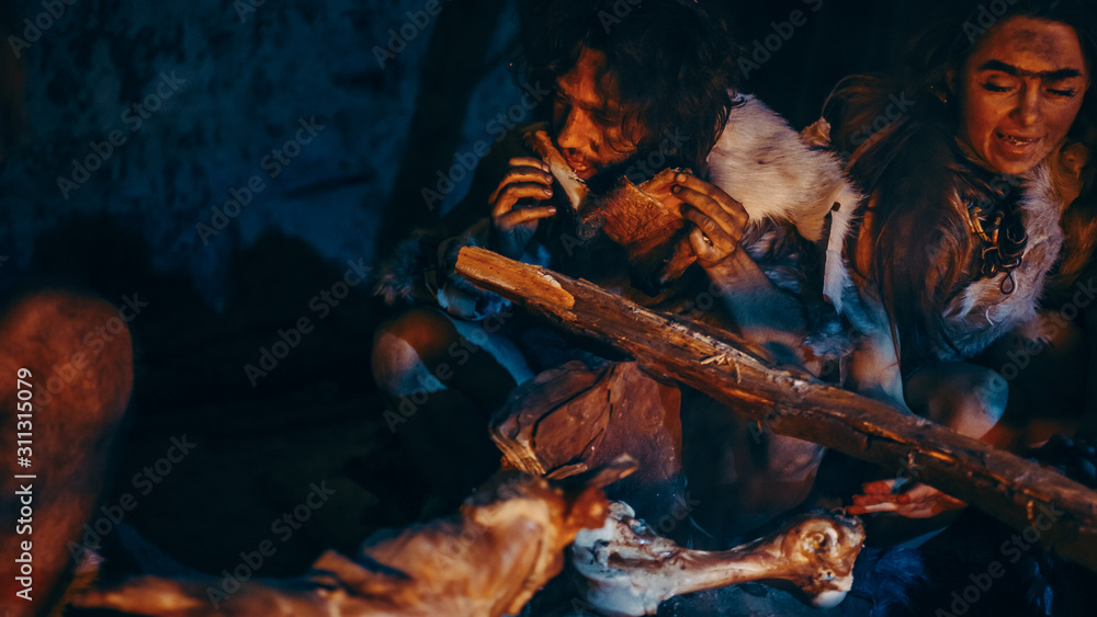 Close-up Shot of Neanderthal or Homo Sapiens Family Cooking Animal Meat ...