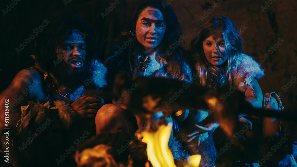 Neanderthal or Homo Sapiens Family Cooking Animal Meat over Bonfire and ...