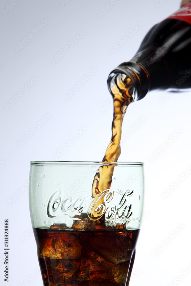 pouring coca cola to coca cola glass with ice cube Stock Photo | Adobe ...