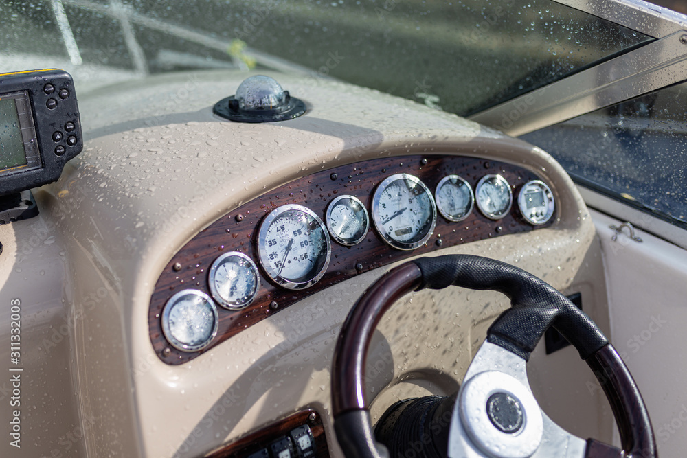 Modern steering wheel on dashboard background of luxury pleasure yacht ...