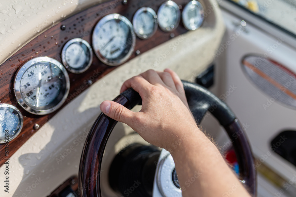 Male hand control the direction of the ship, force the direction of the ...