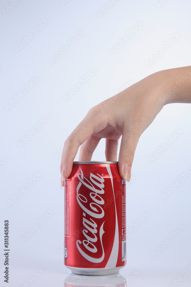 female hand reaching can of coca cola Stock Photo | Adobe Stock