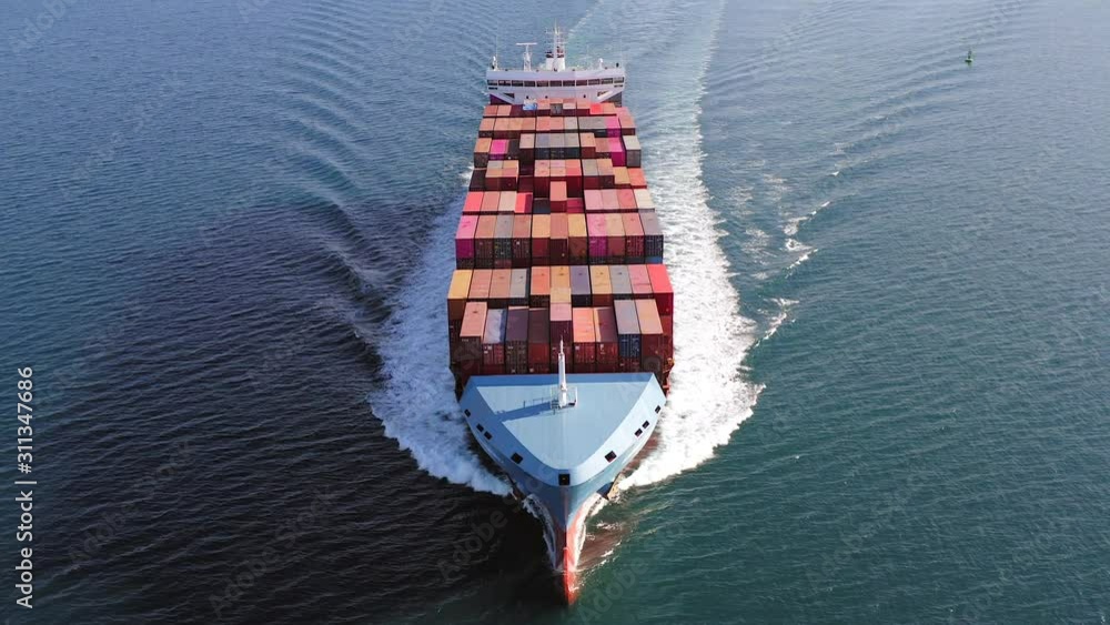 Large loaded Container Ship roaring across the open sea, Aerial view ...