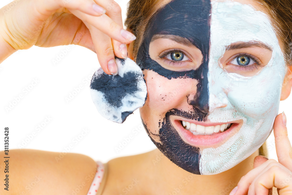 Girl remove black white mud mask from face Stock Photo | Adobe Stock