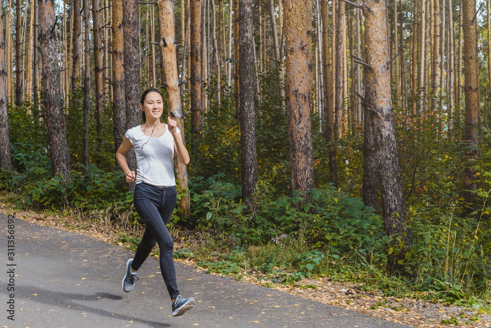 Runner athlete running on a forest trail. woman fitness running workout ...