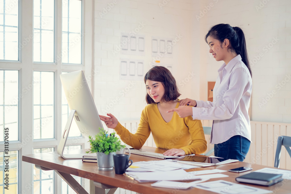 Two young team asian woman of ui ux designer planning and analyze ...