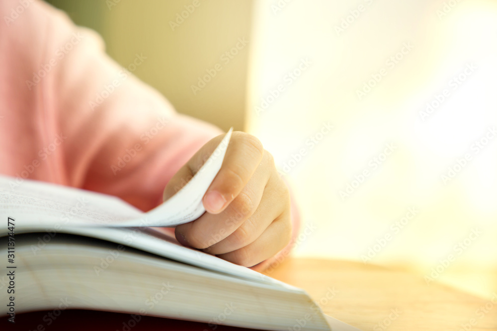 Kid hand open book for reading Stock Photo | Adobe Stock