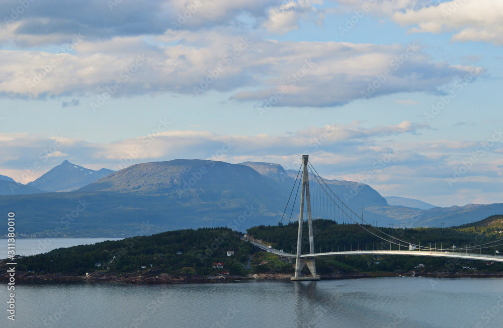 Suspension bridge connecting Islands with mountains in background in ...
