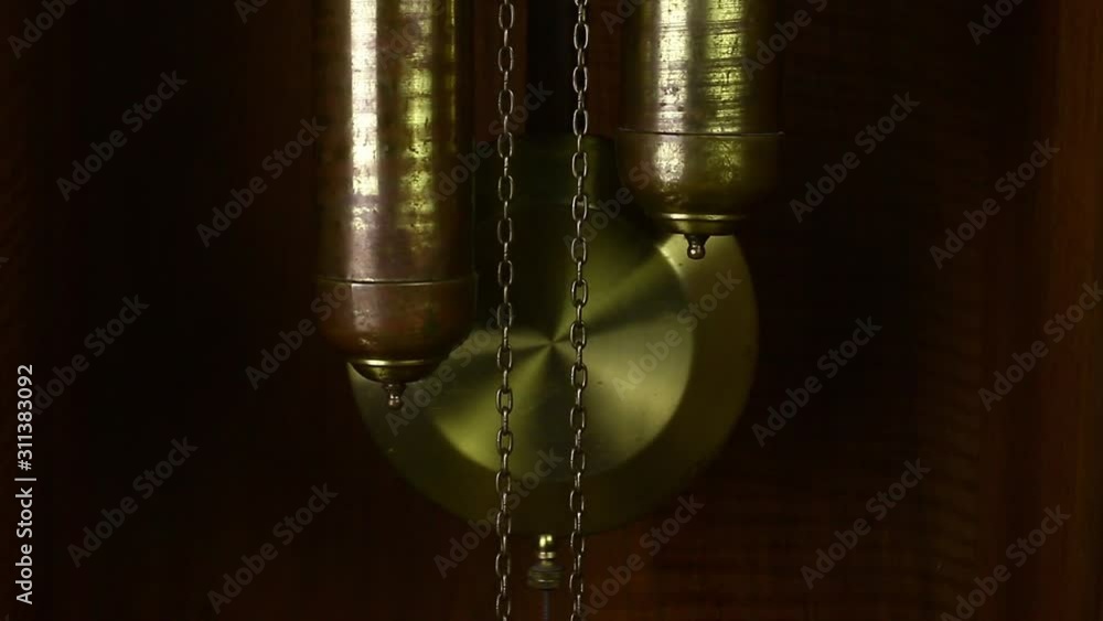 The pendulum of old antique floor clocks and chains with weights. Old ...