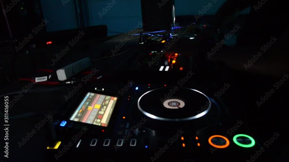 DJ scratching a record, close up. DJ working with his equipment on ...