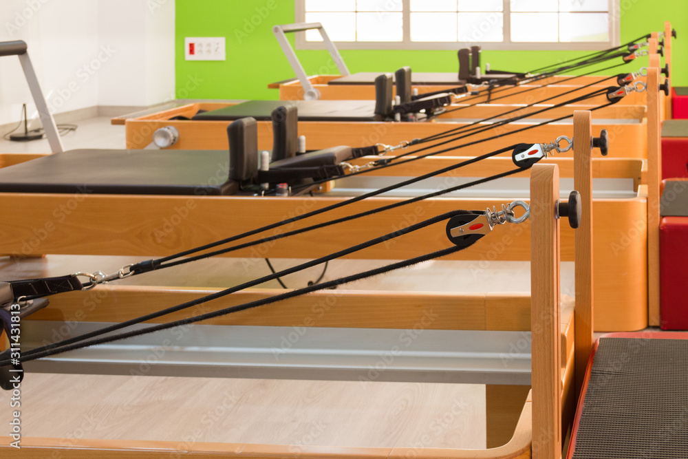 Pilates reformers in a row. Studio equipment, workout, exercise ...