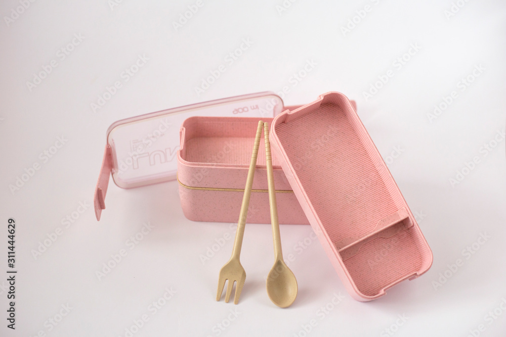 Empty pink lunch box made of wheat straw on a white background ...