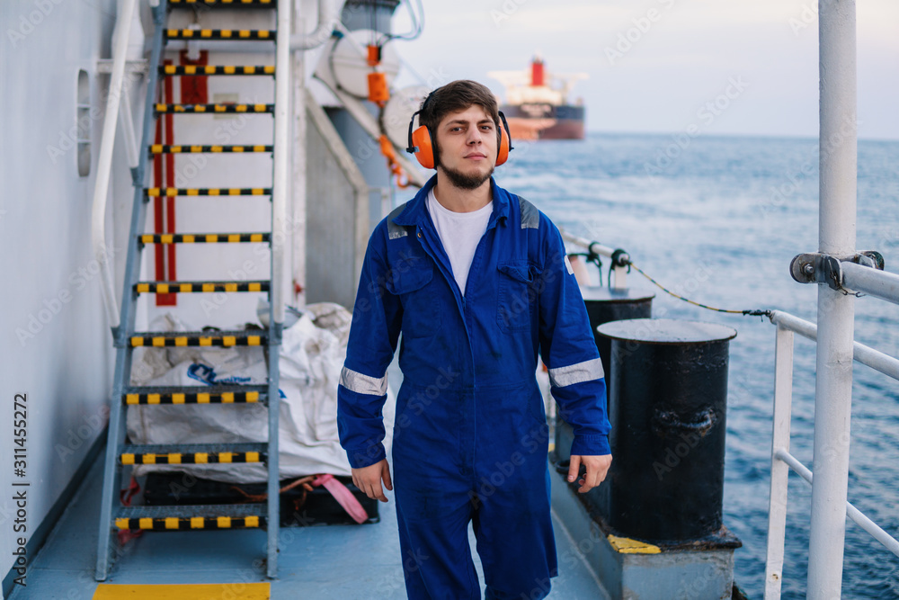 Engineer or officer on deck of offshore vessel or ship , wearing PPE ...
