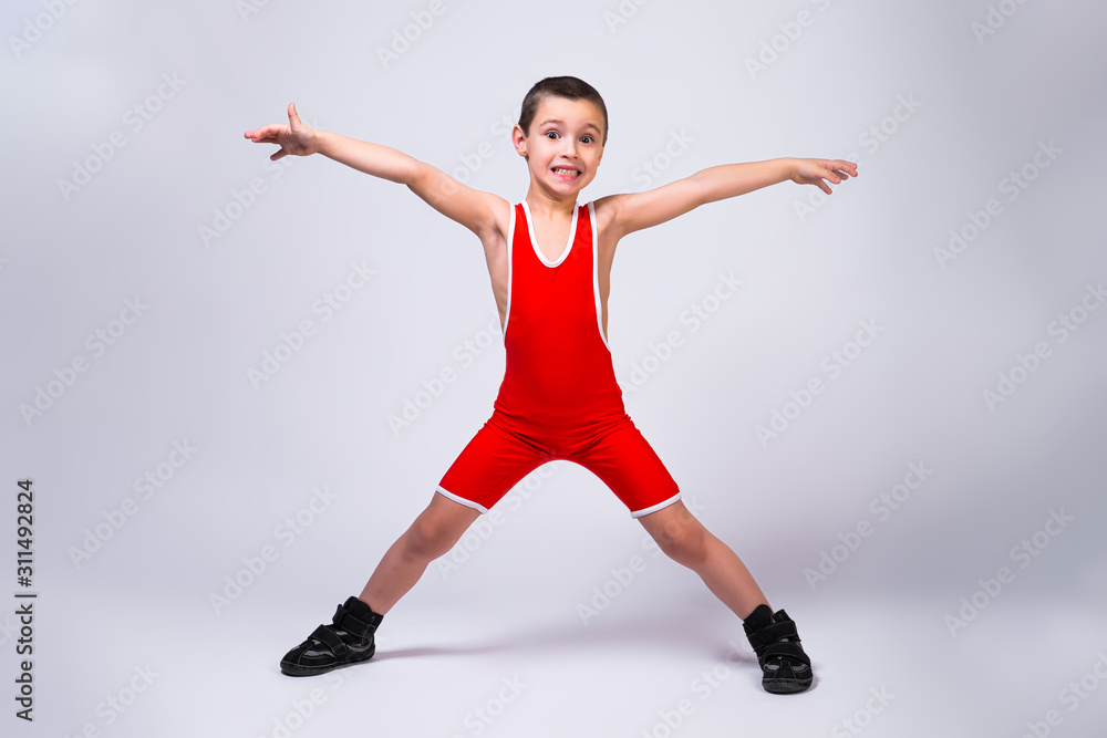 Little funny boy in a red sports ortsovskoy leotard and wrestling boots ...