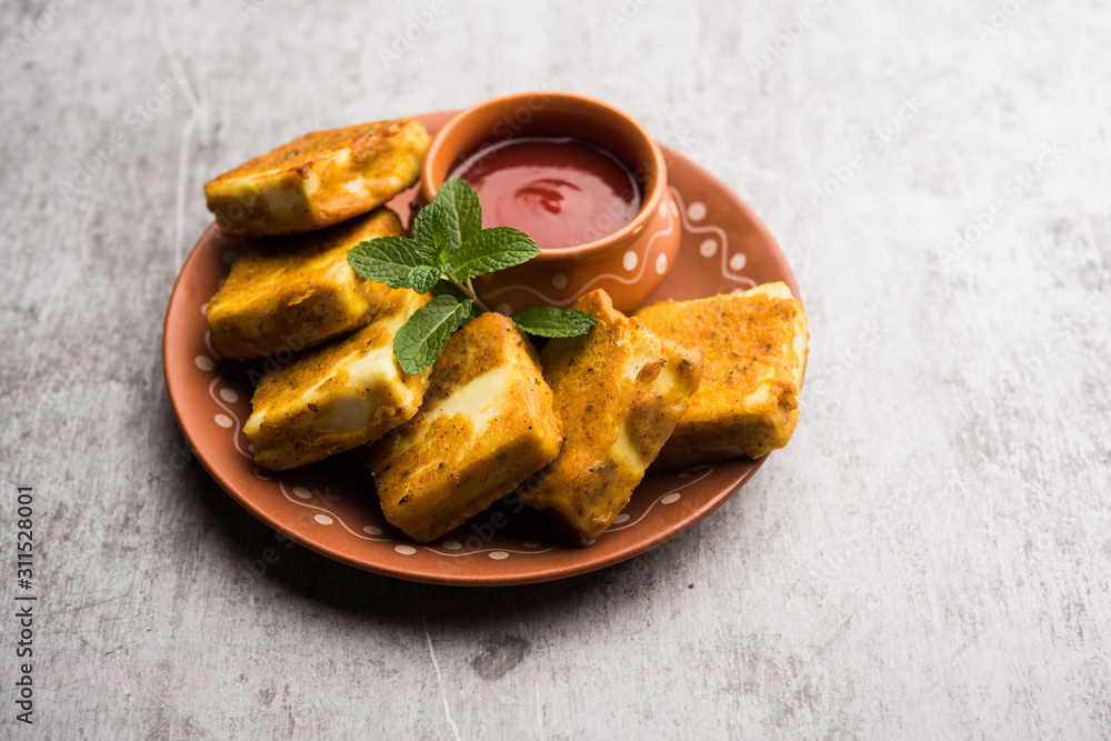 Amritsari Paneer Tikka made using cottage cheese cubes dipped in a ...