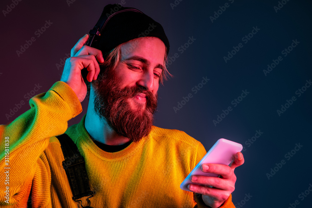 Calm, happy, using phone. Caucasian man's portrait on gradient studio ...