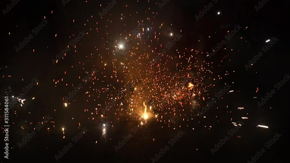Firework for children exploding with sparkles on the ground in front of ...