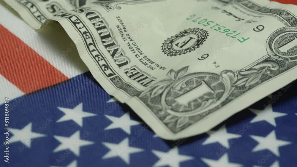 Vidéo Stock famous one dollar bill lies on American flag of red blue ...