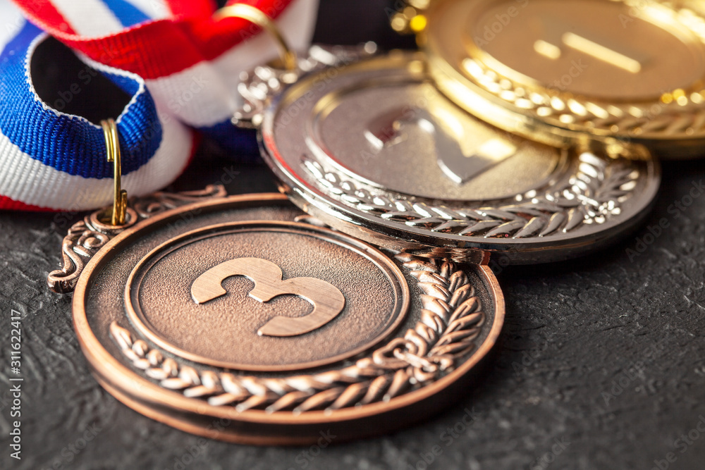 Gold, silver and bronze medal with ribbons. Award for first, second and ...