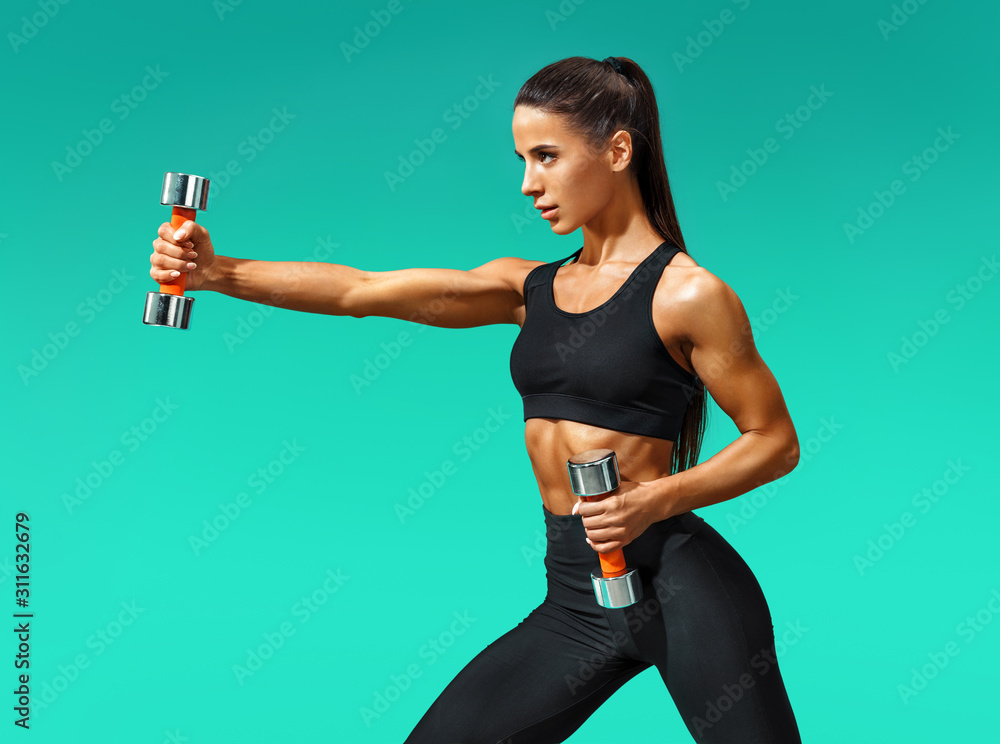 Athletic woman doing exercise for arms with dumbbells. Photo of ...