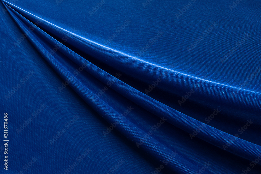 Luxury deep blue fabric background.Smooth wavy fold pattern.Elegant curve.Silk velvet material ...