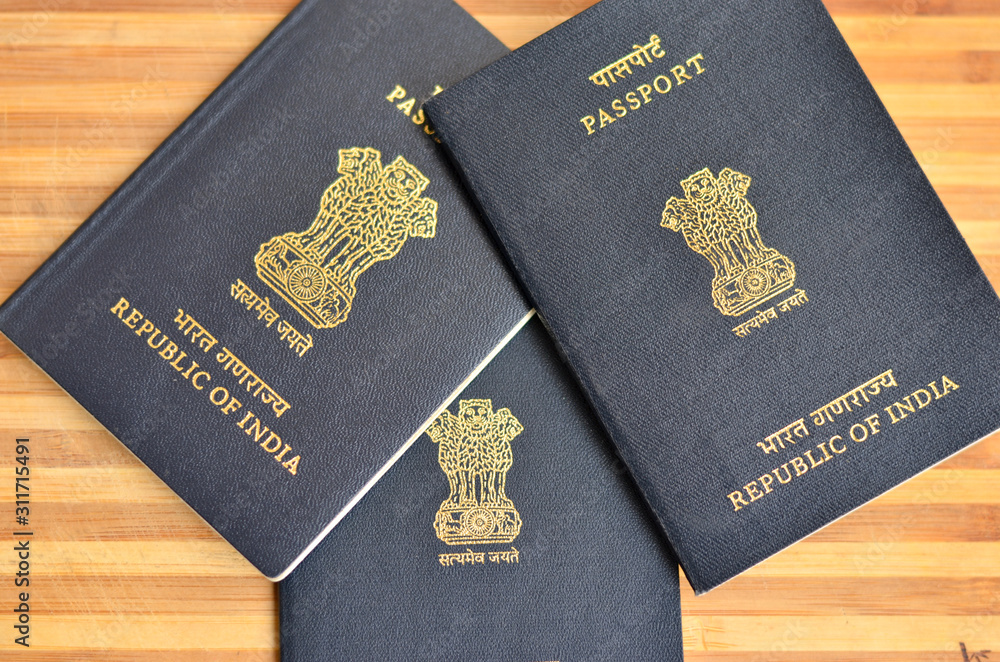Multiple Indian Passports kept against wooden background on display ...