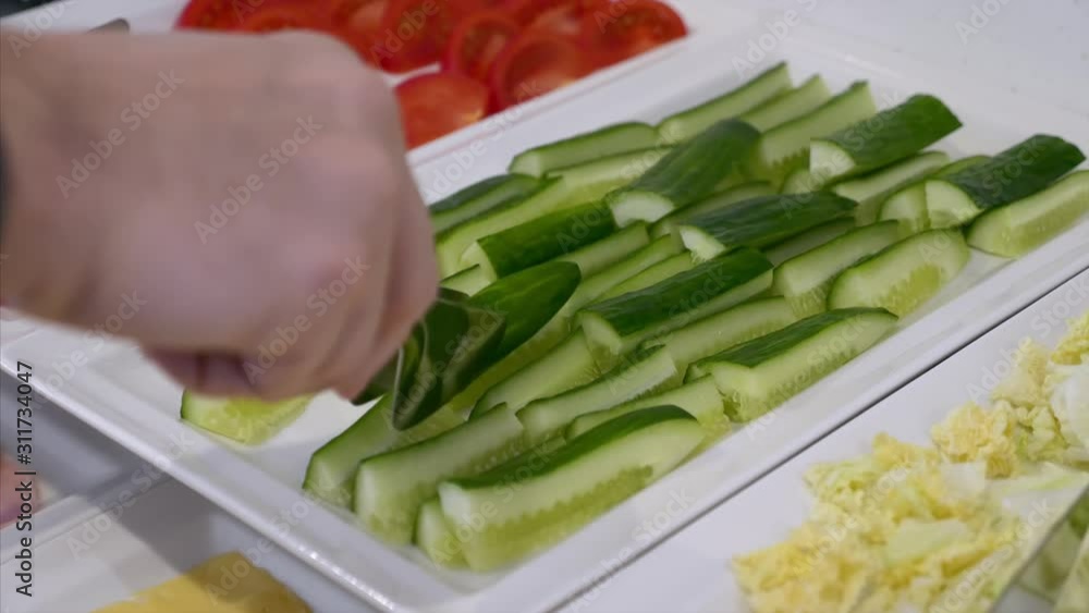 Man Hand Take a Piece of Cucumber from Self-service Buffet Table with ...