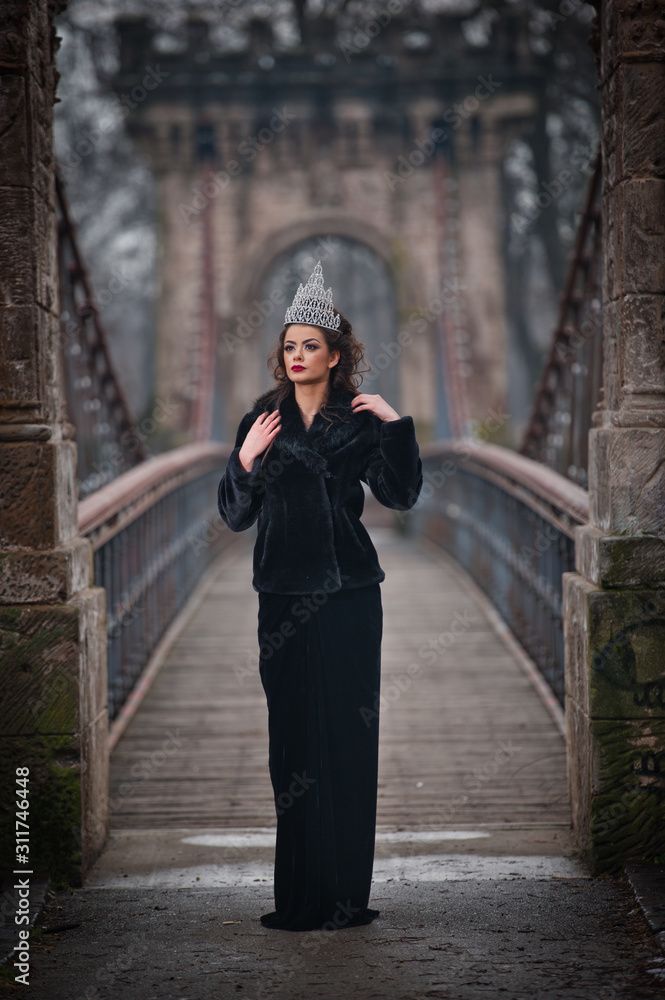 Beautiful fairy-tale winter queen in the forest with sparkling tiara ...