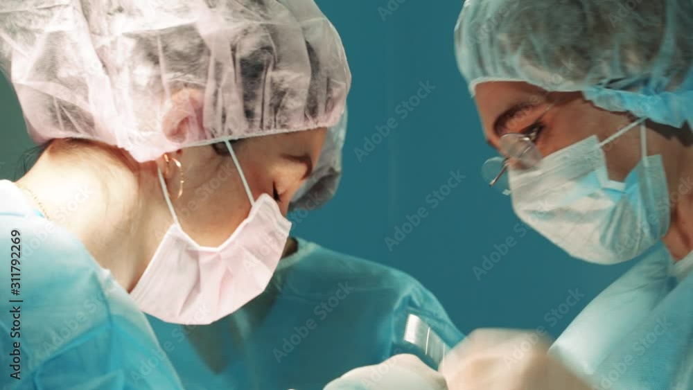 Facial plastic surgery. Teamwork with nurse and surgeon performing ...