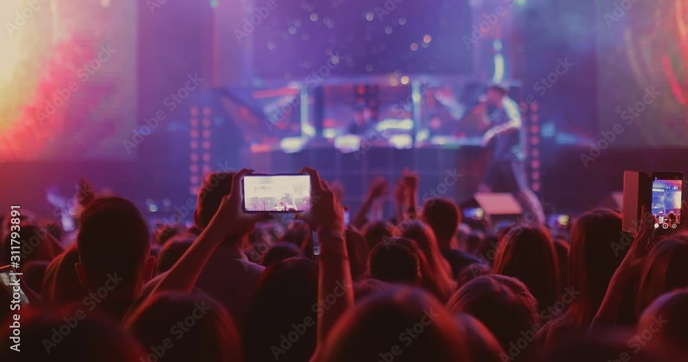 People are filming a singer’s concert on smartphone. Сrowd of people at ...