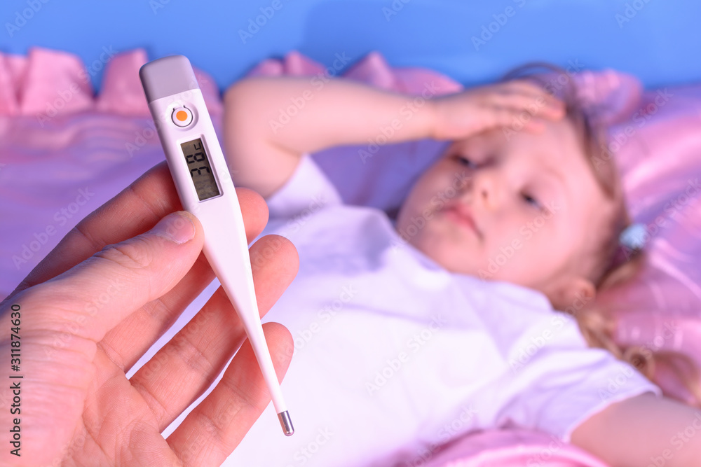 Thermometer for determining body temperature for a sick girl Stock ...
