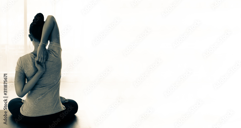 female doing stretching exercises yoga practice. Hands behind back ...