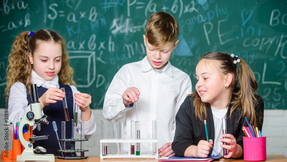 Girls and boy student conduct school experiment with liquids. School ...