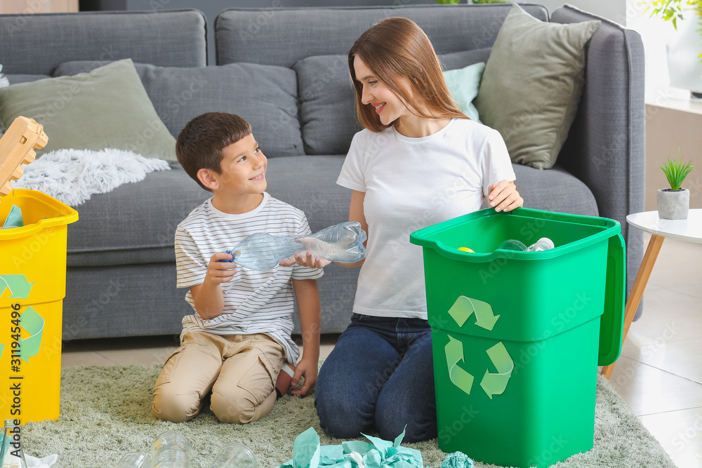 Family sorting garbage at home. Concept of recycling Stock Photo ...