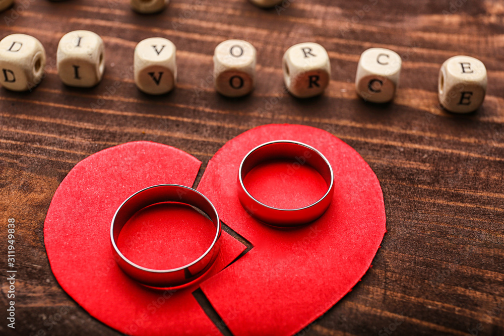 Broken heart, rings and word DIVORCE made of cubes on wooden background ...