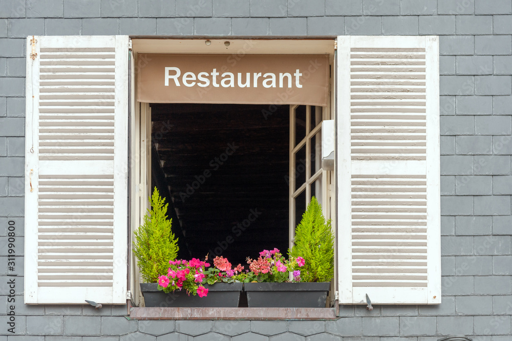 Cozy French restaurant window of typical house in oceanside village ...