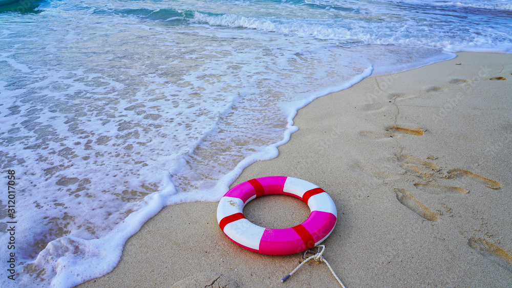 Bright life-saving red-white lifebuoy in the sea floats on the blue ...