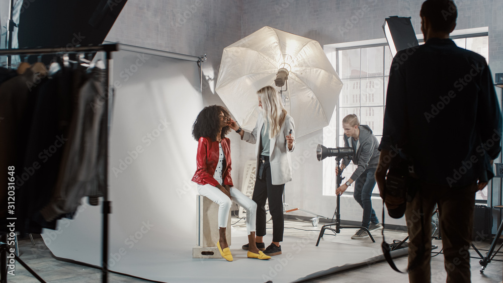Preparations on a Backstage of the Photo Shoot: Make-up Artist Applies ...