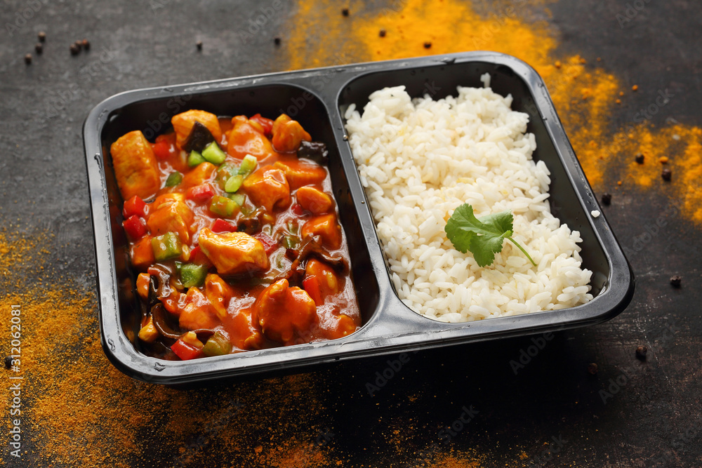 Box diet, Chinese chicken with white rice. Ready dish in a black ...