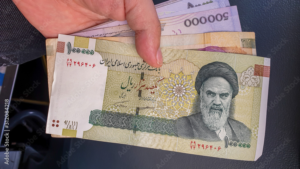Hand holding Iranian Rial. Stock Photo | Adobe Stock