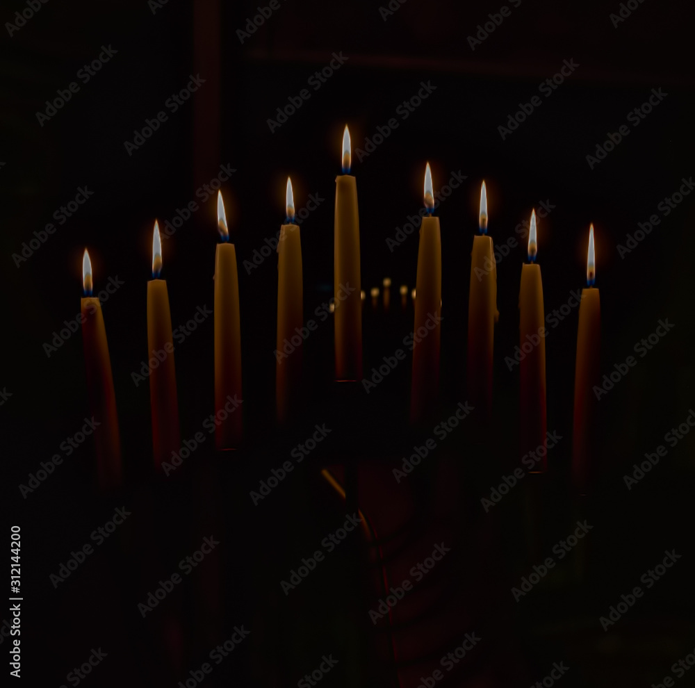 Menorah with lit candles in celebration of Chanukah. A symbolic candle ...