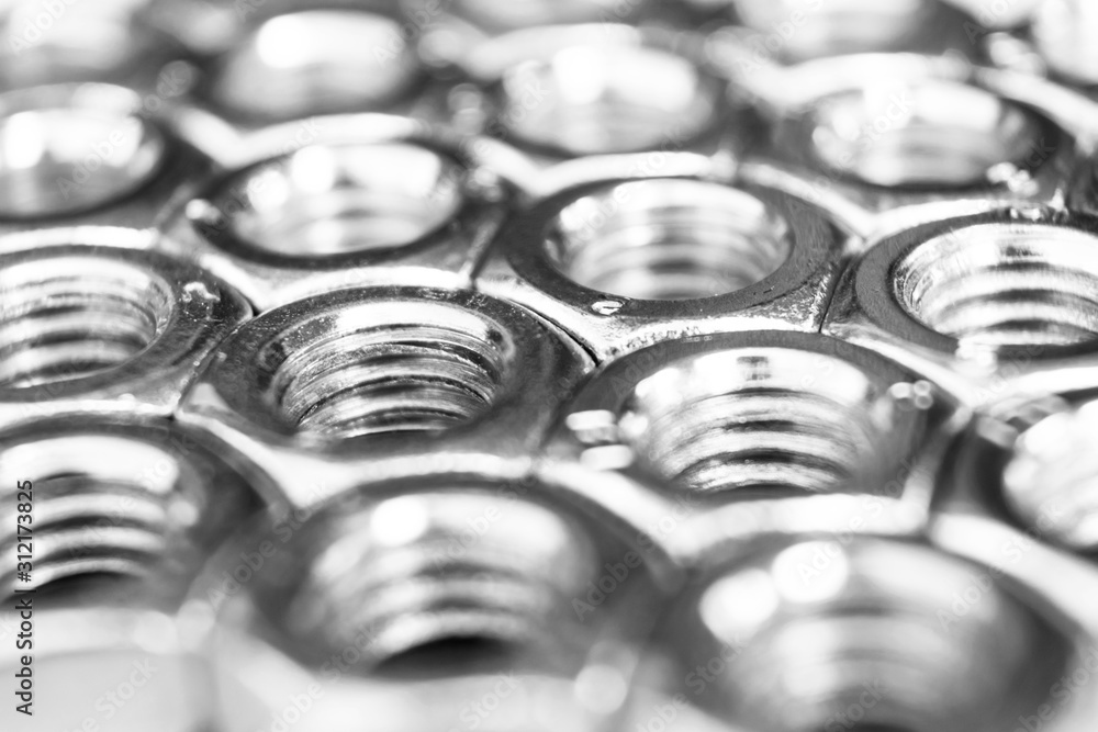 Metal nuts in a row background. Chromed screw nuts isolated. Steel nuts ...