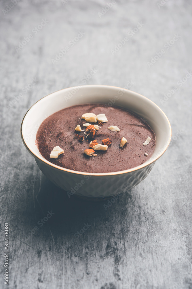 Sweet Ragi Malt / Healthy Ragi Porridge in a bowl garnished with ...