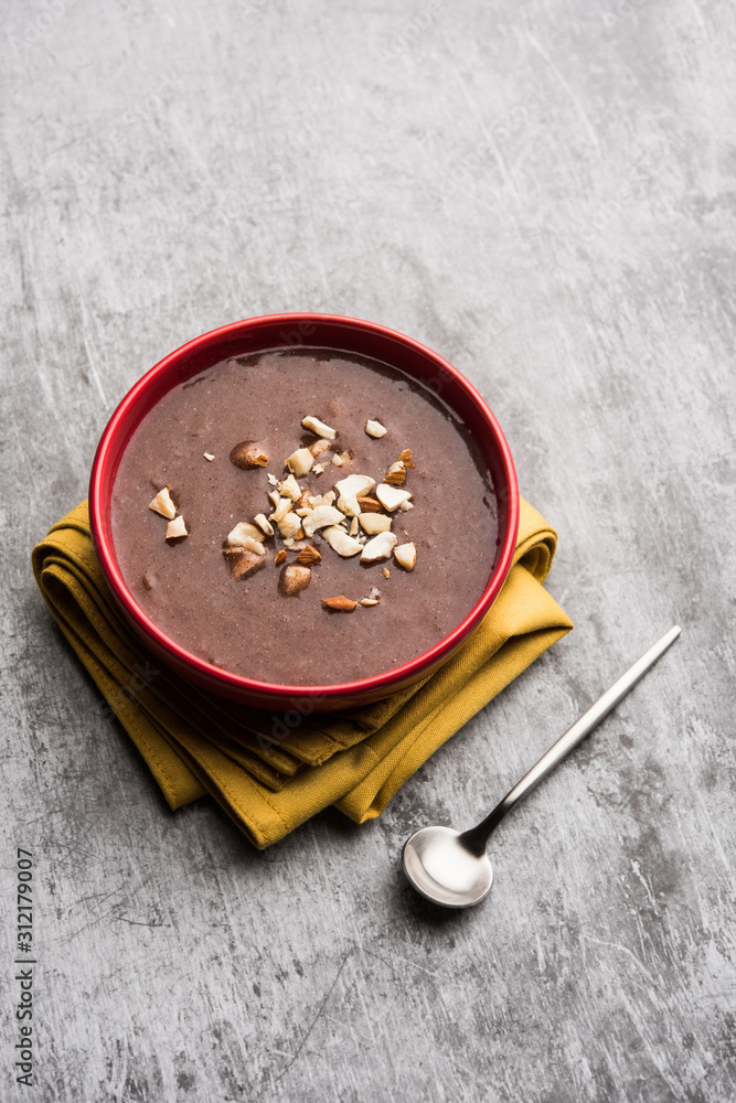 Sweet Ragi Malt / Healthy Ragi Porridge in a bowl garnished with ...