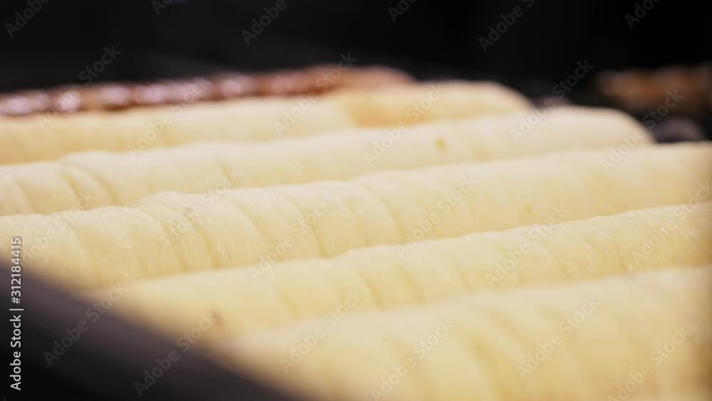 Bakery bun baked on a wooden cylinder. Background for commercial baking ...