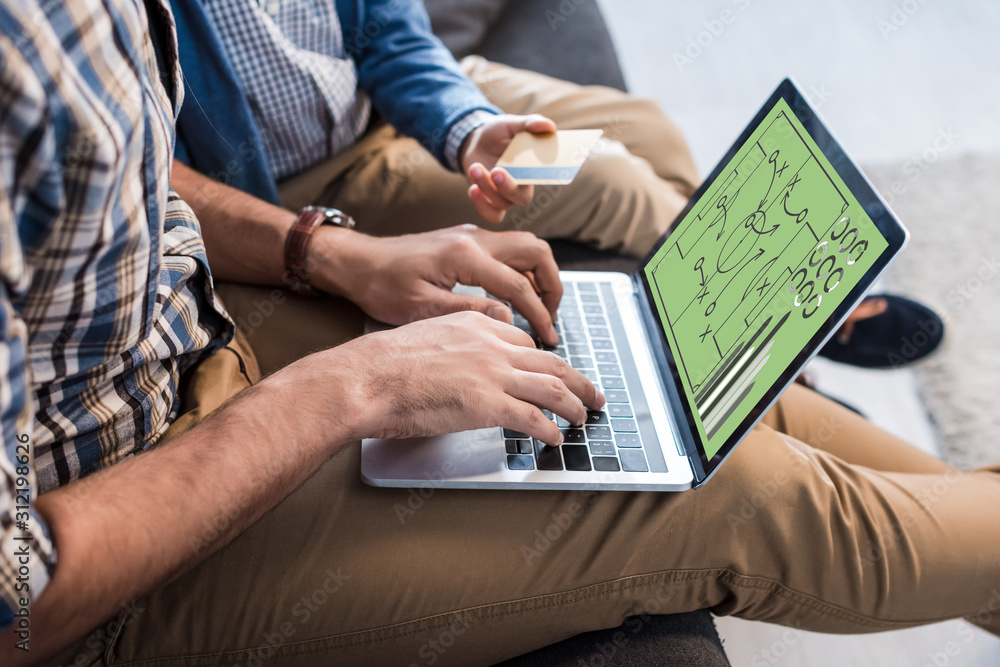 cropped view of jewish father using laptop with charts on screen and ...